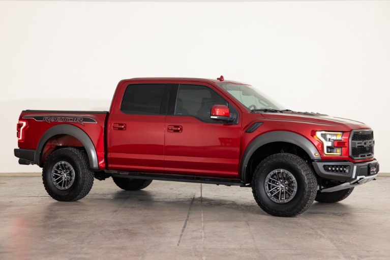 Red Ford Raptor Lifted